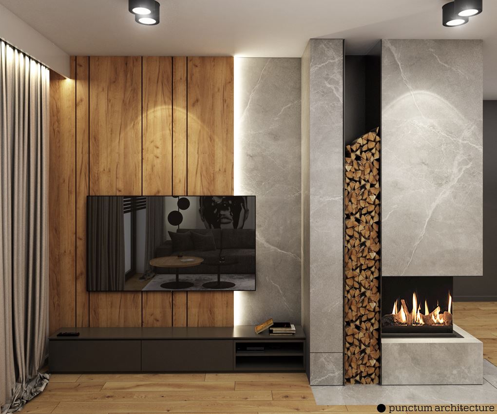 Kominek w kamieniu i telewizor na tle drewna w salonie - Domni.pl